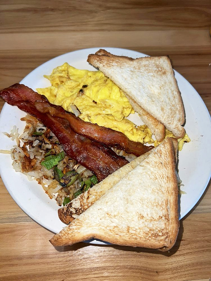Breakfast perfection on a plate&mdash;golden eggs, crispy potatoes, and toast that's ready for its supporting role in the morning symphony.