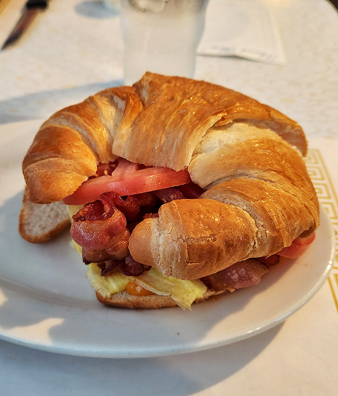 The breakfast sandwich that launched a thousand satisfied sighs. Flaky croissant, eggs, bacon, and cheese&mdash;morning's greatest hits album on a plate.