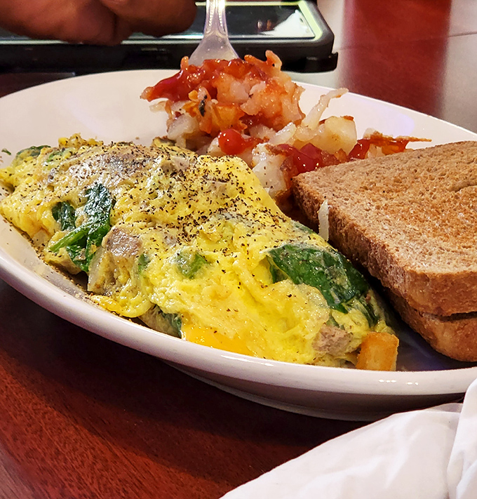 An omelet filled with fresh veggies alongside perfectly bronzed hash browns&mdash;the breakfast power couple that's been happily married for decades.