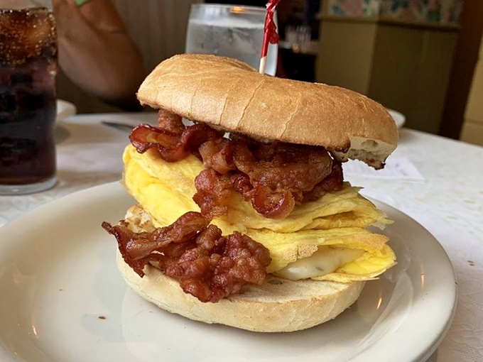 The breakfast sandwich hierarchy has a new champion—this towering creation with perfectly folded eggs and crispy bacon demands a two-handed commitment.