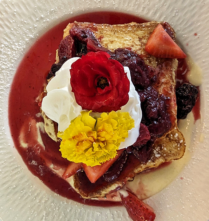 French toast that makes regular bread feel inadequate. Swimming in berry compote and adorned with flowers&mdash;breakfast or edible art installation?