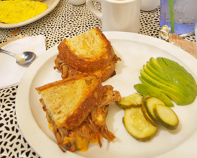 The brisket sandwich arrives like a meaty masterpiece, with perfectly toasted bread and fresh avocado playing supporting roles.