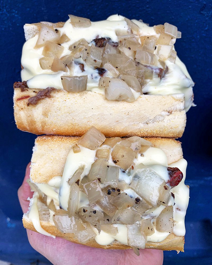 The Brisket Cheesesteak &ndash; where Philadelphia tradition meets Texas smoke in a handheld miracle. Cooper Sharp cheese sauce cascades over tender brisket like a dairy waterfall.