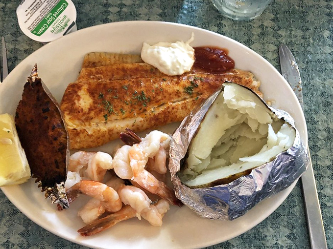 When broiled seafood meets baked potato, it's not just dinner &ndash; it's a relationship worth celebrating. That butter sauce deserves its own fan club.