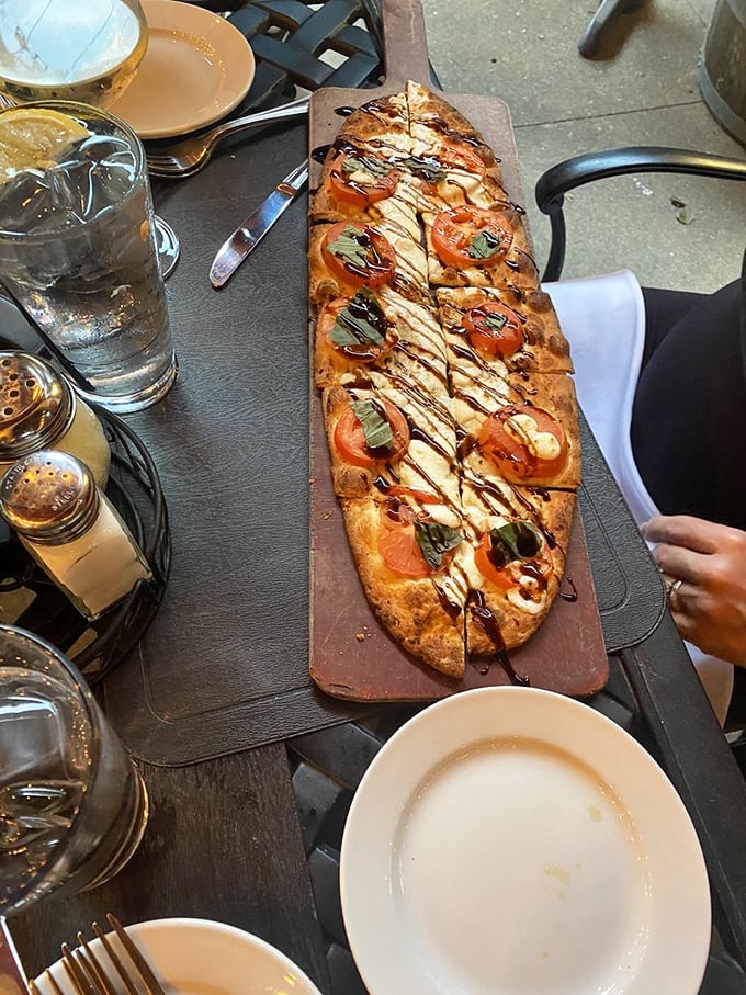 This flatbread is what happens when Italy and art have a delicious baby. Fresh tomatoes, basil, and balsamic drizzle create an edible masterpiece.