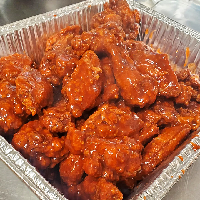 Buffalo wings wearing their sauce like a badge of honor, ready to challenge your spice tolerance.