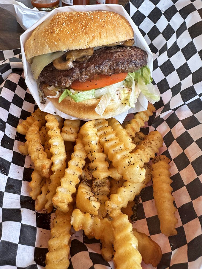 A burger that requires both hands and a strategy. Those seasoned crinkle fries aren't just a side dish&mdash;they're part of the conversation.