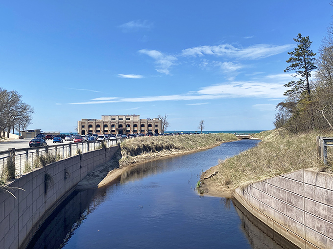 Where nature and infrastructure meet in peaceful coexistence. This canal creates a serene boundary between the developed park facilities and the wild beauty beyond.