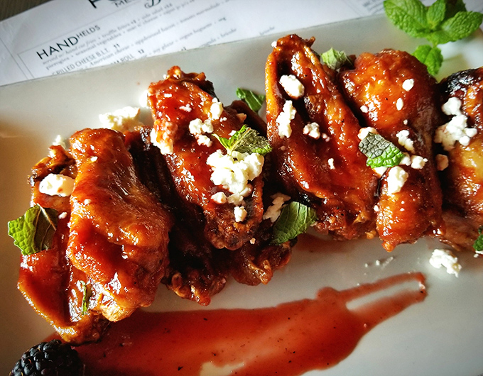 Who knew wings could get a standing ovation? These sauce-glazed beauties are topped with crumbled cheese and fresh mint for an unexpected flavor symphony.