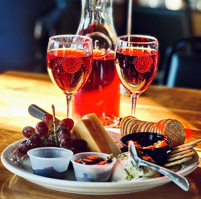 Wine and cheese: civilization's greatest achievement since indoor plumbing, presented here with grapes, crackers, and Midwest generosity.