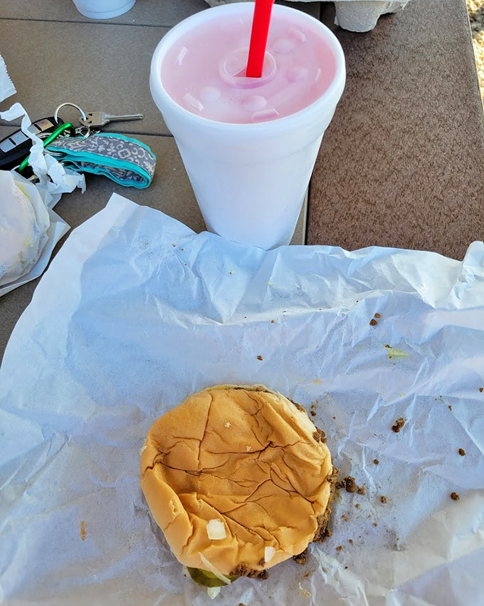 Two halves of heaven &ndash; the perfect ratio of soft bun to seasoned meat with a pickle peeking out like it's playing hide and seek.