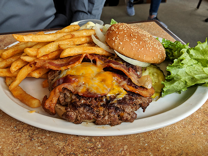 Behold the American dream on a plate: a burger crowned with melted cheese and bacon that makes you temporarily forget about concepts like "cholesterol" and "moderation."