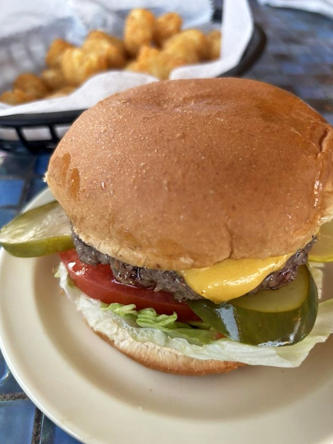 The classic cheeseburger in its natural habitat. Fresh lettuce, tomato, pickles, and a perfectly melted slice of American cheese complete this masterpiece.