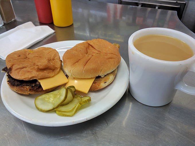 Two perfectly grilled cheeseburgers with pickle spears and a mug of coffee—the blue-collar special that's sustained Detroit through good times and challenging ones.