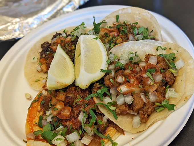Chicharron tacos with lime wedges standing at attention &ndash; a perfect balance of crunch, chew, and zing that makes your taste buds stand up and salute.