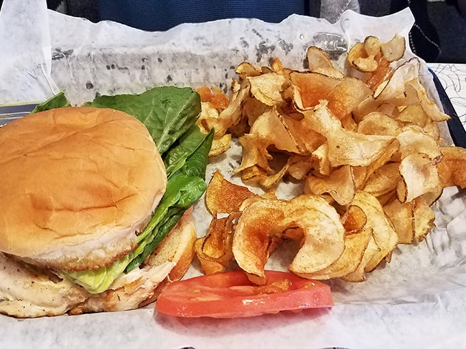 The star of the show—a perfectly grilled chicken sandwich with fresh veggies and those homemade chips that shatter with satisfying crispness.