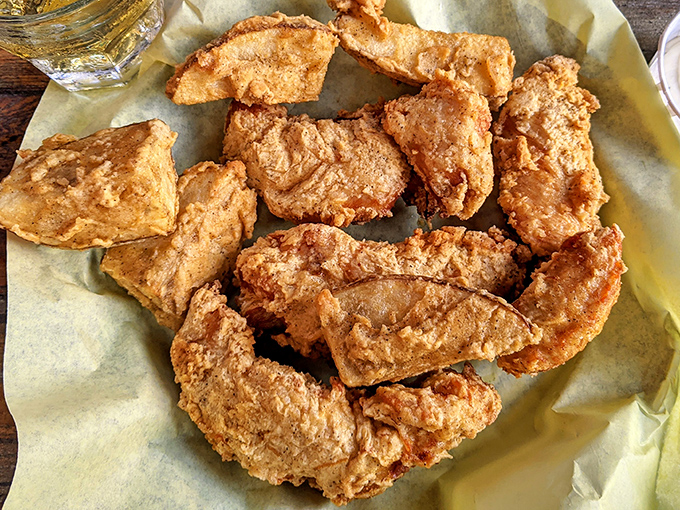 Chicken tenders and jojos lounging on parchment like they know they're the stars of the show. Humble ingredients transformed into culinary celebrities.