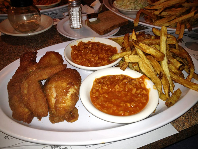 Barberton chicken, served with traditional sides, creates a perfect trinity of flavors. The crisp exterior practically shatters when your fork makes contact.