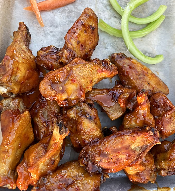 These wings aren't just glazed—they're dressed for the prom of flavor, glistening with sauce that demands both napkins and respect.