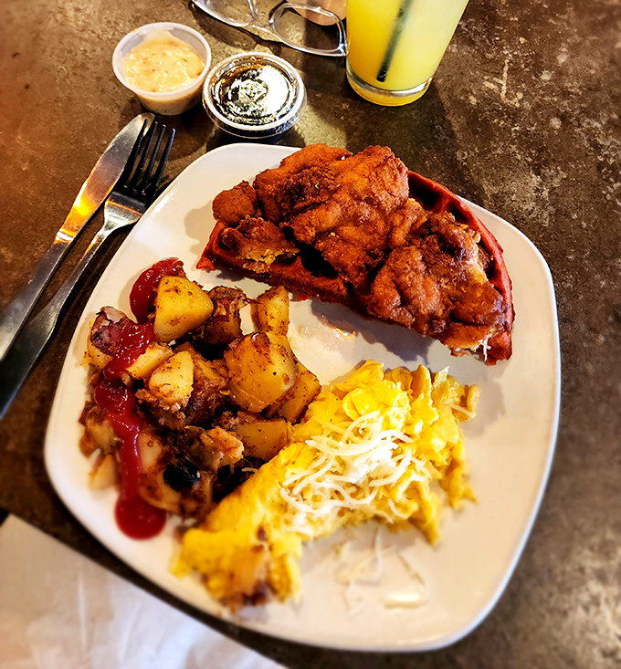 Southern comfort reimagined: crispy fried chicken perched atop a red velvet waffle with potatoes and eggs. Breakfast or lunch? Yes, please.