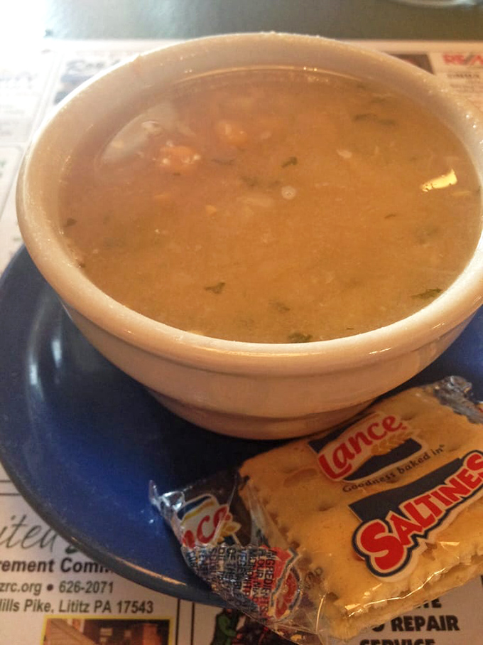 The legendary chicken corn soup &ndash; golden broth, tender chicken, sweet corn kernels, and delicate egg ribbons &ndash; served with crackers for proper dunking.