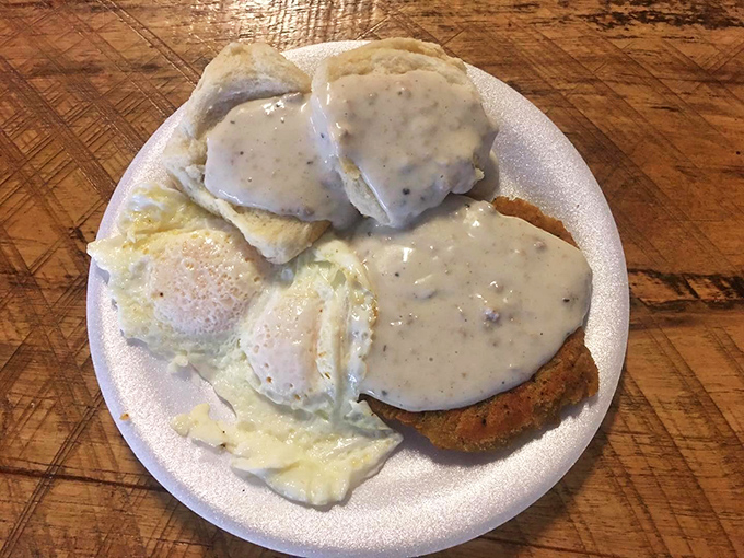 Biscuits swimming in pepper-flecked gravy alongside eggs that look like they were laid this morning. Southern comfort on a plate.