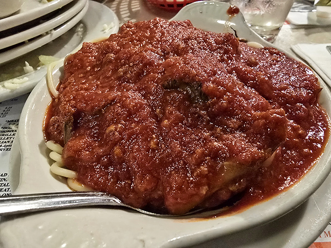 Spaghetti with meat sauce that makes you wonder if your grandmother has been moonlighting in Luigi's kitchen. The pasta-to-sauce ratio is mathematical perfection.