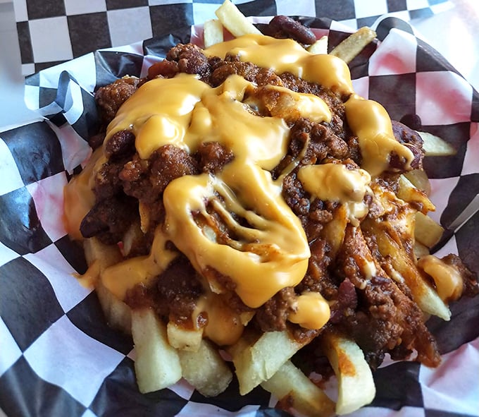 Chili cheese fries loaded with enough toppings to fuel a cross-country road trip through flavor town.