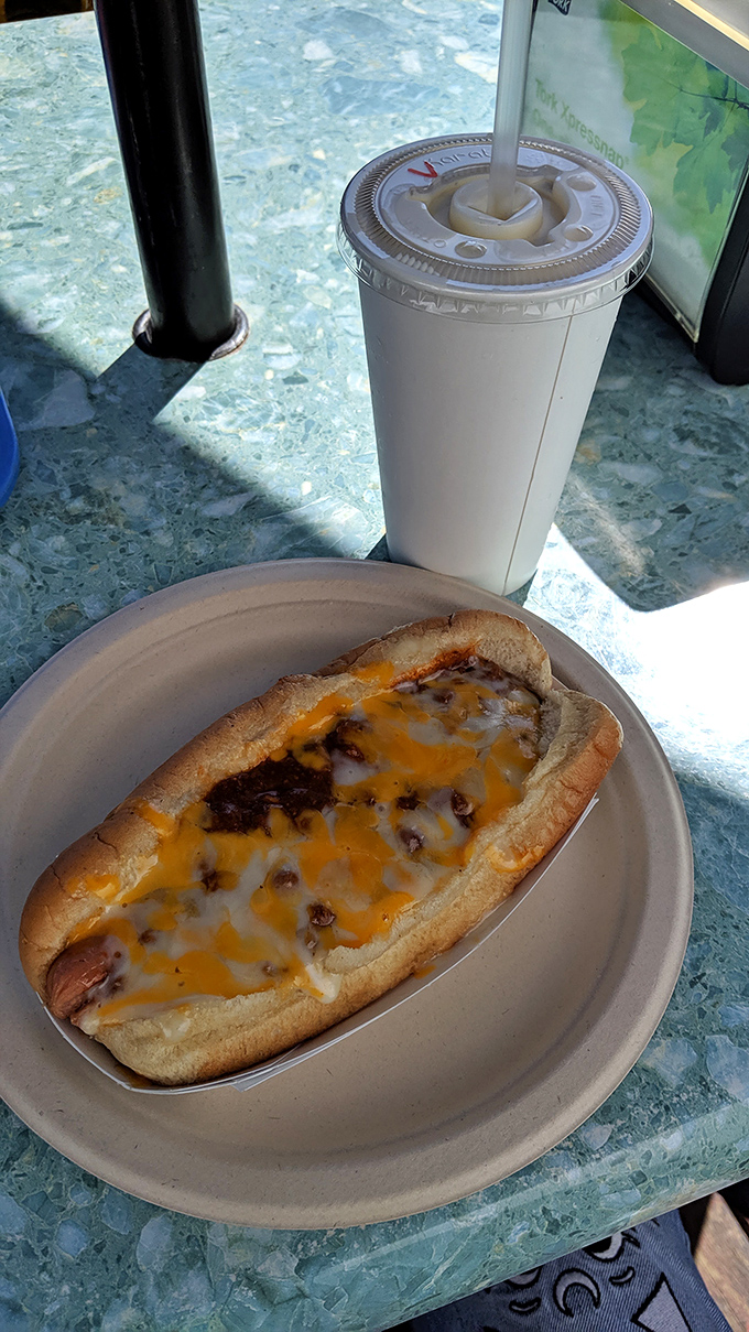 A chili cheese dog that doesn't care about your white shirt, delivering messy perfection that makes napkins essential and regrets impossible.