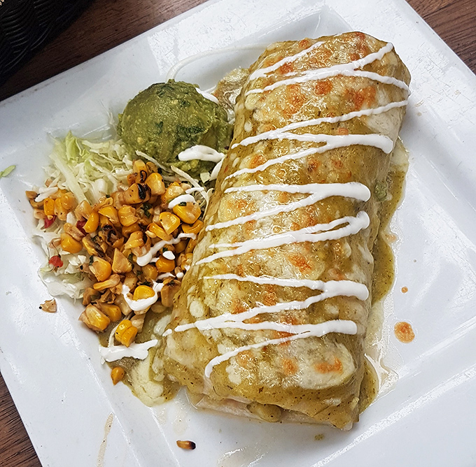 This chimichanga is living its best life, all golden-crisp outside and steamy-delicious inside, dressed up in zigzags of cream that mean business.