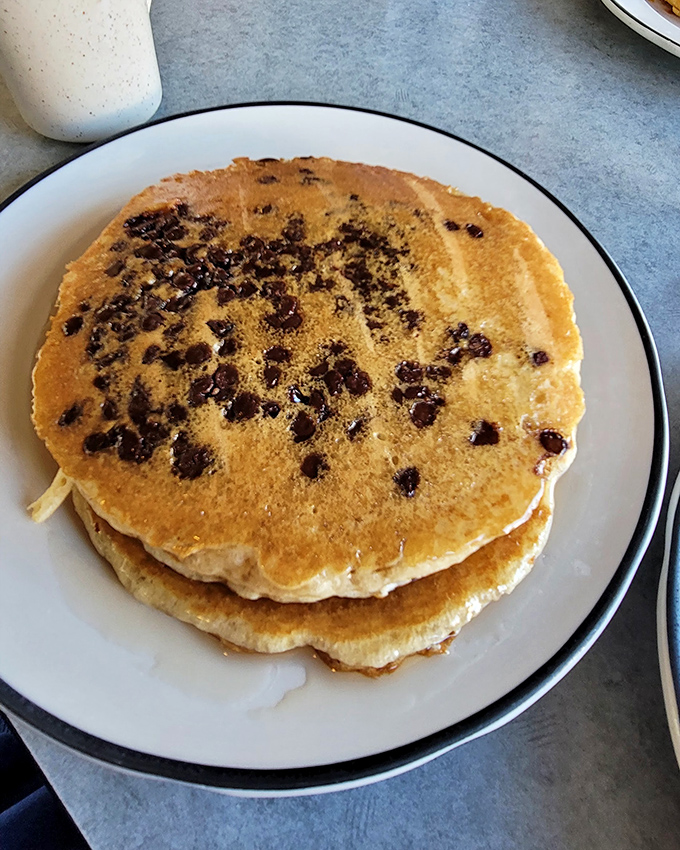 Chocolate chip pancakes stacked like edible gold coins. Each bite delivers that nostalgic Saturday morning feeling we all crave.