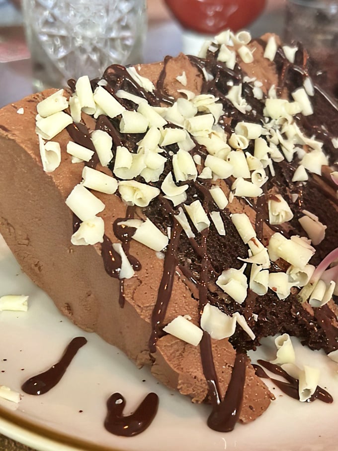 The chocolate mousse cake that launched a thousand return visits. Those white chocolate shavings aren't just decoration&mdash;they're exclamation points. 