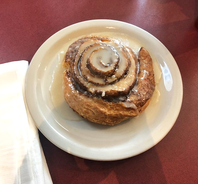 This cinnamon roll isn't just breakfast&mdash;it's an architectural marvel of spiraled dough and glaze that demands to be admired before being devoured with childlike enthusiasm.