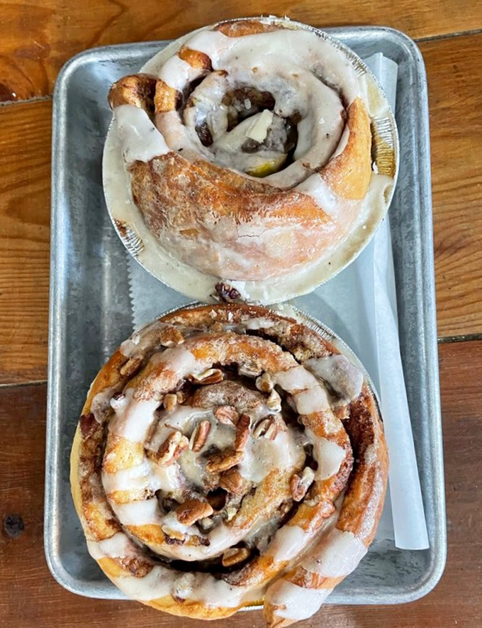 These cinnamon rolls spiral into sweet oblivion, each swirl promising a journey through butter, sugar, and pure morning bliss.