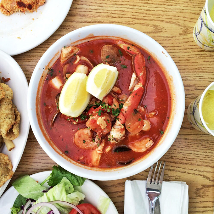 The cioppino &ndash; a tomato-based seafood symphony where every spoonful delivers a different ocean treasure. This isn't soup; it's an underwater expedition.