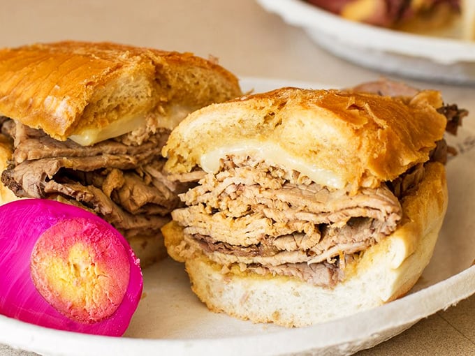 The classic beef dip with its vibrant pink pickled egg sidekick – a color combination that shouldn't work but somehow becomes culinary poetry.