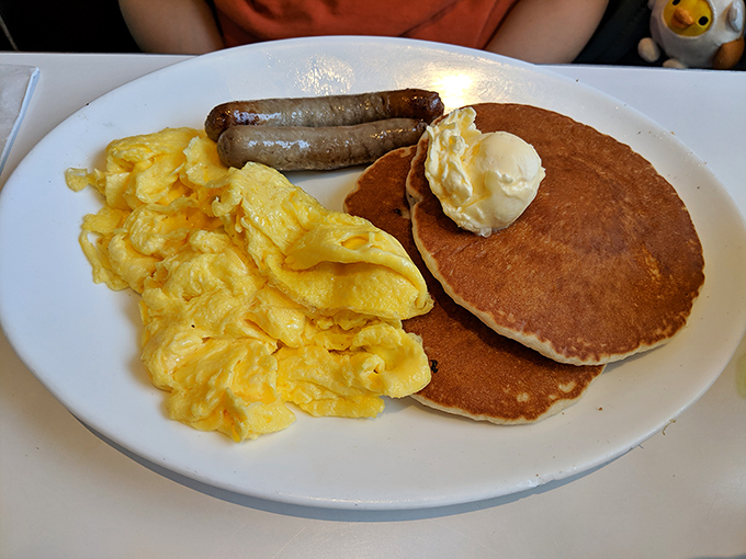 The breakfast that launched a thousand Saturday mornings. Fluffy pancakes, scrambled eggs, and sausage links&mdash;the holy trinity of diner breakfasts done right.