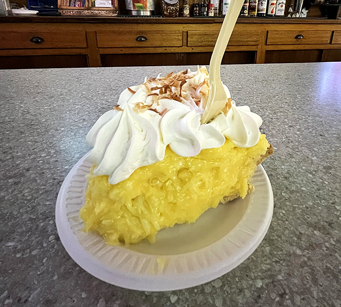 The coconut cream pie practically glows with golden filling and pillowy whipped cream. It's the kind of dessert that makes you consider skipping the sandwich entirely.