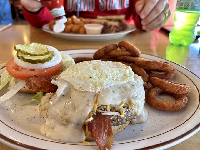 This breakfast sandwich, smothered in country gravy with onion rings on the side, isn't just comfort food&mdash;it's a warm hug on a plate.