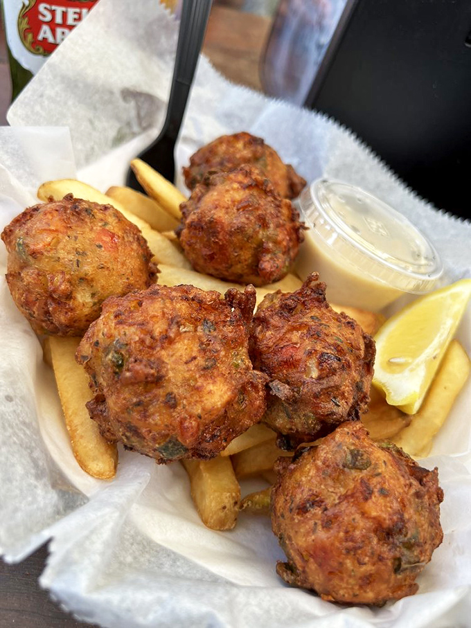 Fried clam strips lounging on a bed of fries—the seafood equivalent of sprawling on a beach chair after a swim.