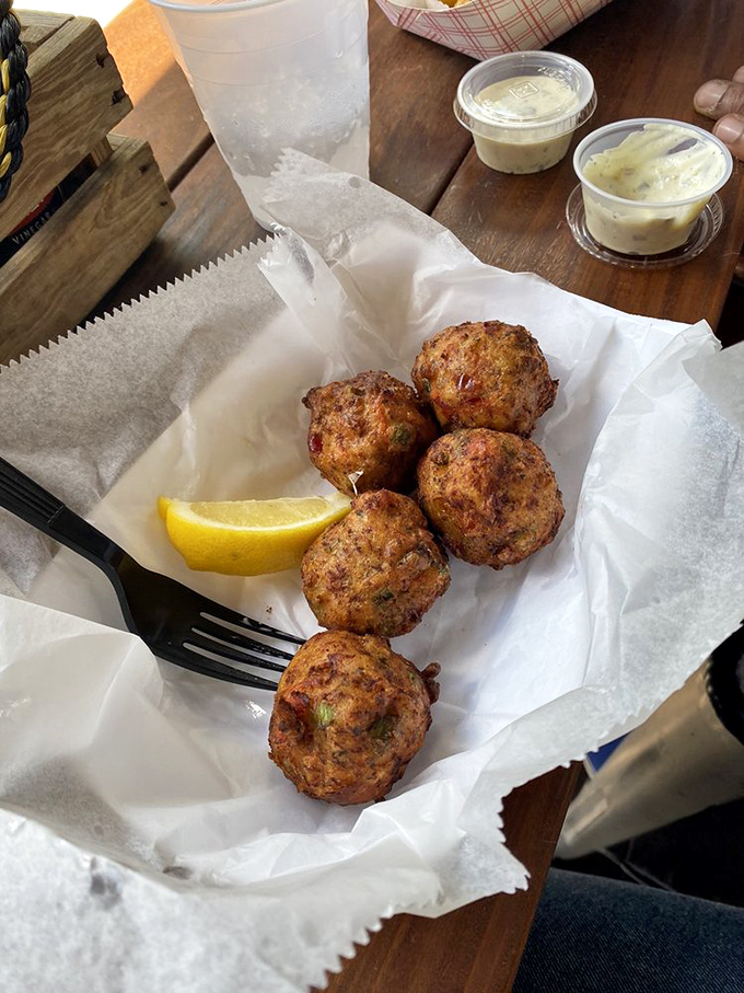 Golden-brown conch fritters that crunch like your childhood memories, then melt into savory island bliss with each bite.