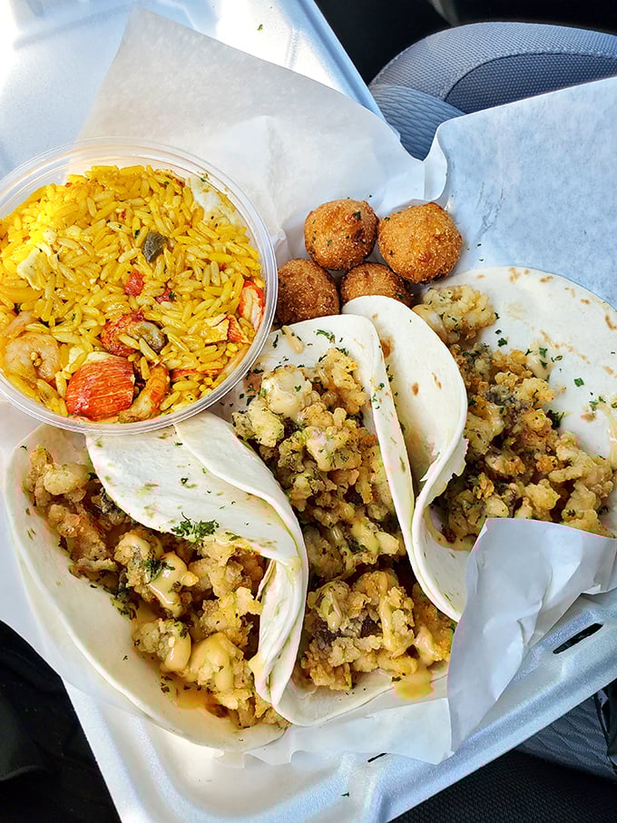 A holy trinity of seafood tacos, yellow rice, and hush puppies. The kind of meal that makes you contemplate moving closer to the truck's regular parking spot.