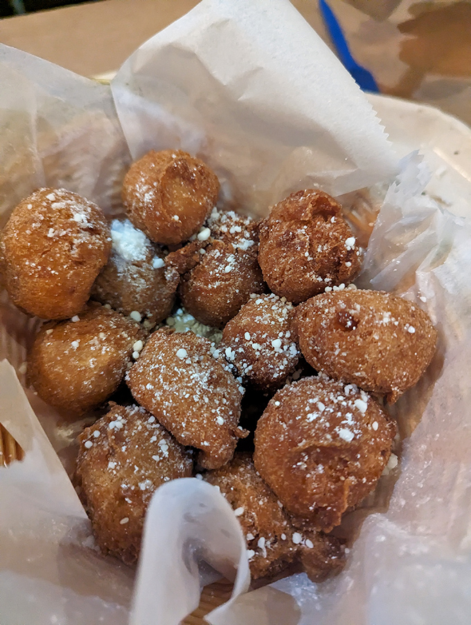 Corn fritters that look like they're wearing little powdered sugar snowcaps&mdash;crunchy outside, fluffy inside, and utterly irresistible.