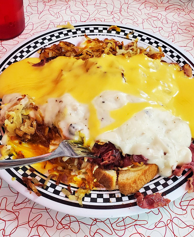 That t-shirt says it all&mdash;"Eat It & Beat It"&mdash;while below, a plate of golden-fried goodness drowning in cheese sauce promises you'll do exactly that.