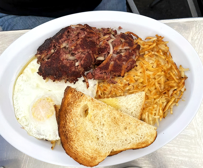 Corned beef hash that hasn't seen the inside of a can, eggs with yolks the color of sunrise, and toast that's actually toasted. Simple perfection.
