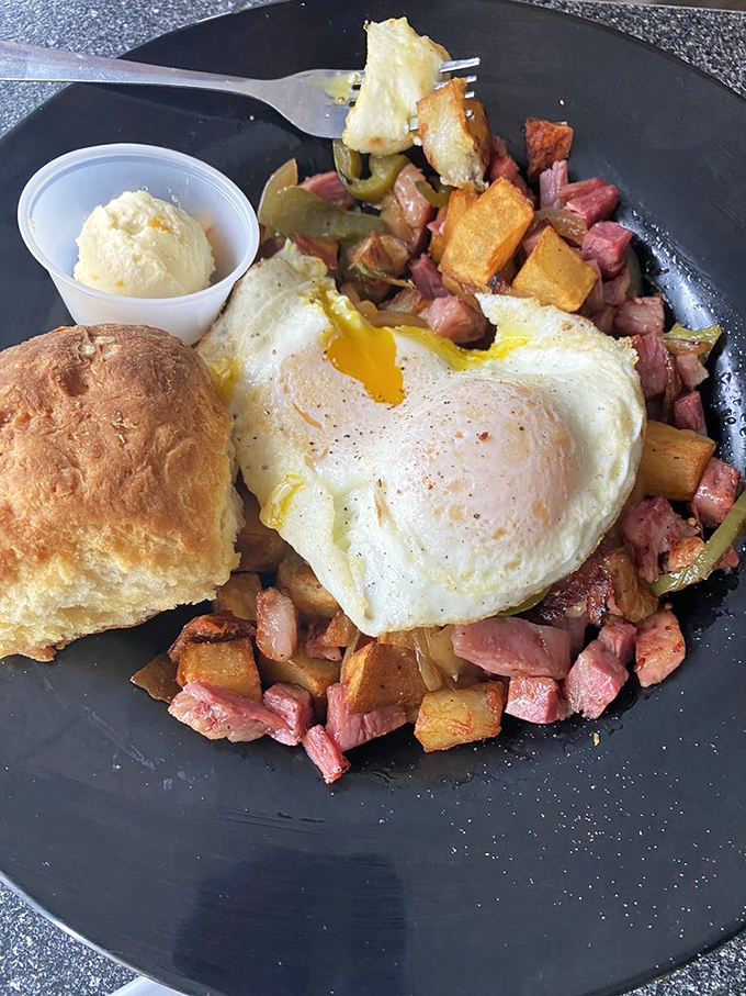This isn't just corned beef hash—it's a masterpiece topped with a perfectly cooked egg whose yolk is about to create breakfast magic.