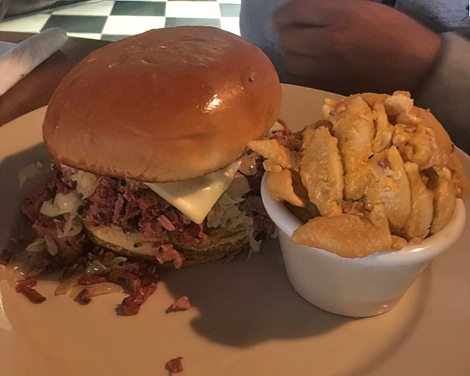 This sandwich rebellion stacks meat so high it practically needs air traffic control. The side of crispy potatoes isn't just a wingman, it's a co-star.