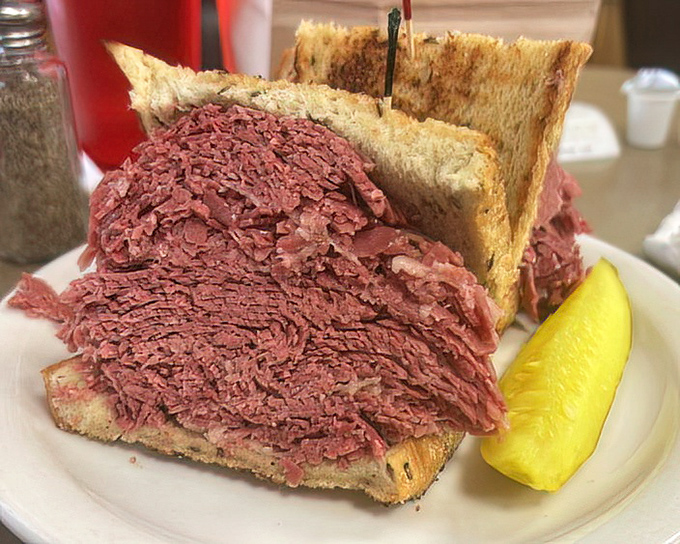 This isn't just a sandwich; it's an engineering marvel. The bread exists merely as a suggestion for how to handle this corned beef mountain.