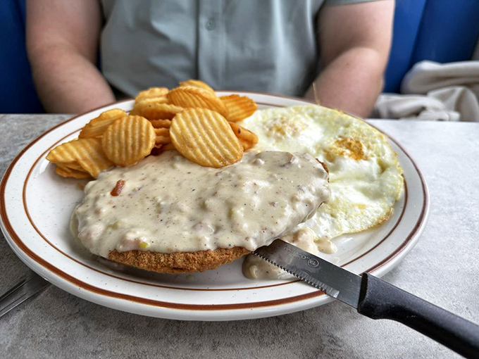 Country fried steak smothered in creamy gravy alongside sunny-side-up eggs&mdash;the kind of breakfast that makes you want to skip lunch altogether.