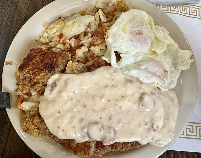 Country fried steak swimming in gravy like it's training for the Comfort Food Olympics. Gold medal performance in every bite.